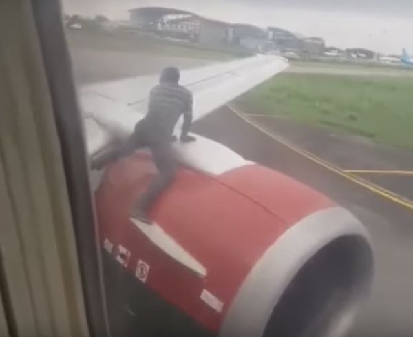 Man Climbs Onto Plane Wing